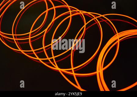 Unusual glowing thin red thread, twisting wire, structural and curved ...