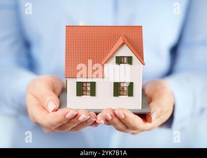 Small toy house in hands Stock Photo - Alamy