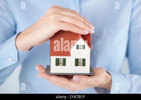 Small toy house in hands Stock Photo - Alamy