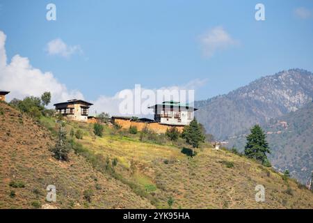 Traditional Bhutanese building complex nestled on a hillside, Paro ...