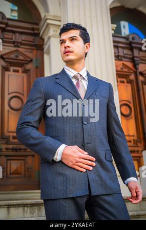 A business professional stands confidently with a hand-drawn world ...