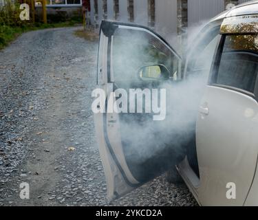 Smoke is coming from under the hood of the car Stock Photo - Alamy