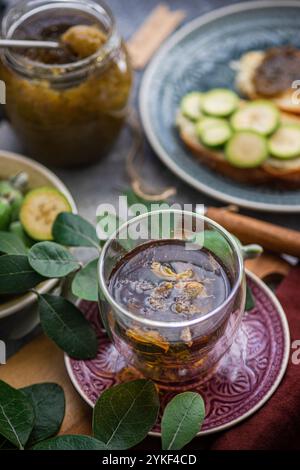 A cozy setup featuring floral tea paired with sandwiches smeared with ...