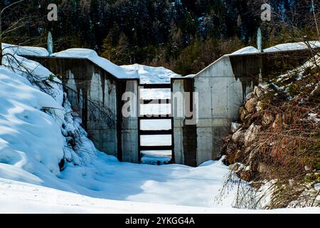 dam open on a stream and submerged by snow Stock Photo - Alamy