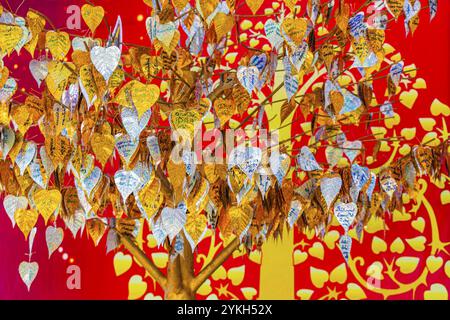 Make merit golden and red money tree at colorful Wat Don Mueang Phra ...