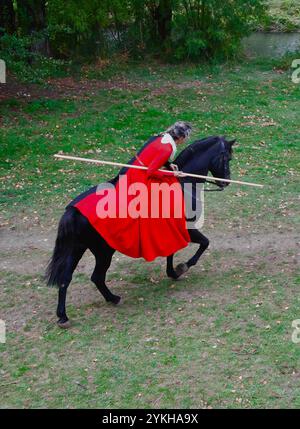 Woman in red dress rides a horse in early spring Stock Photo - Alamy