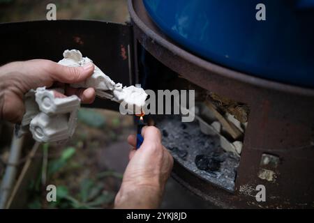 male hands starting fire in a fire pit Stock Photo - Alamy