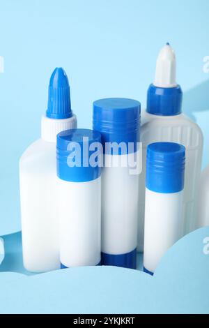 Different types of glue on light blue background, flat lay Stock Photo ...