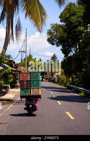 People are riding a heavily loaded motorcycle. Asian people are ...