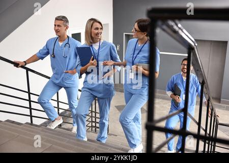 Healthcare workers walking up stairs in hospital Stock Photo - Alamy