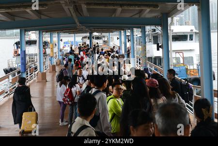 Passengers standing in line wafting to board the ferry to Tung Ping ...