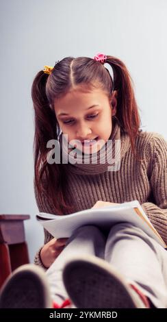 Education concept. The student does homework, reads a book with a ...