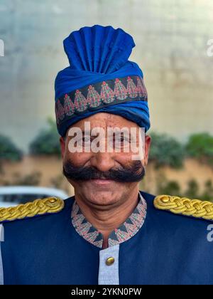 Closeup of an indian guard wearing a ceremonial outfit and a vibrant ...
