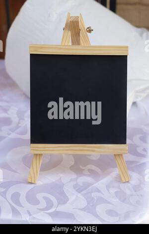 Space wooden easel black on wooden background Stock Photo - Alamy