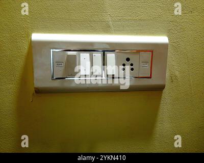 View of white, electrical switchboard containing switches, sockets and ...