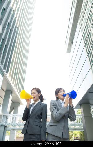 Woman shouting into megaphone, low angle view, cropped Stock Photo - Alamy