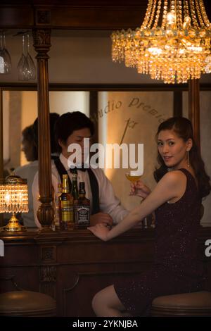 Female customer drinking cocktail with barman Stock Photo - Alamy