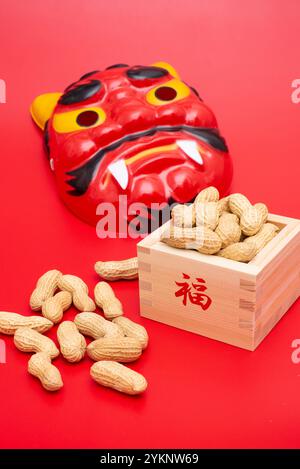Groundnut in Masu Box with Red Devil Mask Stock Photo - Alamy
