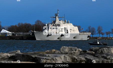 Sunshine breaks through a rainy morning to shine upon the USS Beloit ...