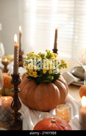 Beautiful table setting with candles and pumpkins Stock Photo - Alamy