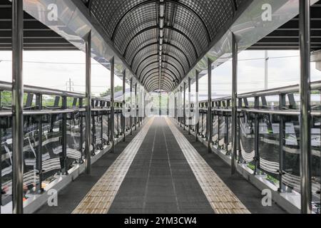 Pedestrian pathway or corridor or hallway between train station and ...