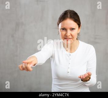 Woman argues while pointing accusingly with fury and anger Stock Photo ...
