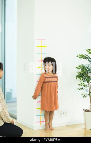 Girl being measured for height Stock Photo - Alamy