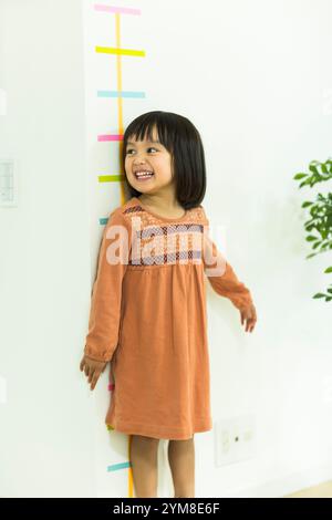 Girl being measured for height Stock Photo - Alamy