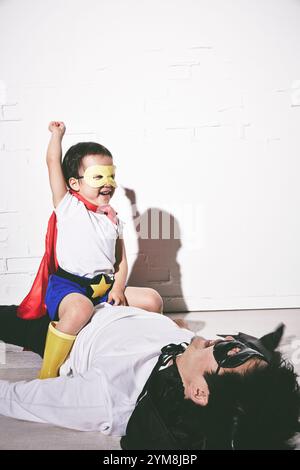 Hero boy fighting off bad guys Stock Photo - Alamy