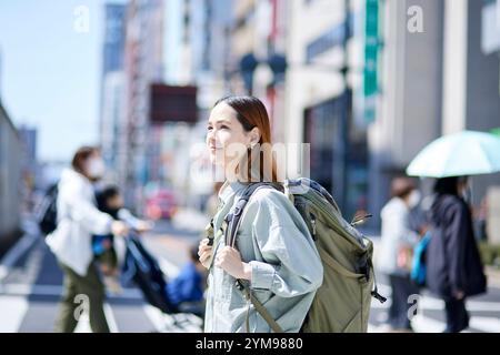 Female inbound backpacker walking with backpack on her back Stock Photo ...