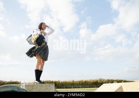 Female student standing and looking into the distance Stock Photo - Alamy