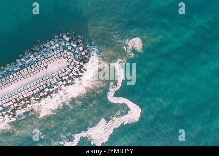 Coastal breakwater for the protection of a harbor, aerial view with a ...