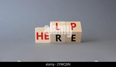 Help is here symbol. Turned wooden cubes with words Here to Help ...
