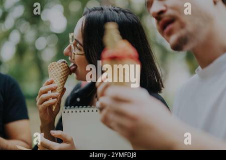 Students enjoying ice cream with professor after classes outdoors Stock ...