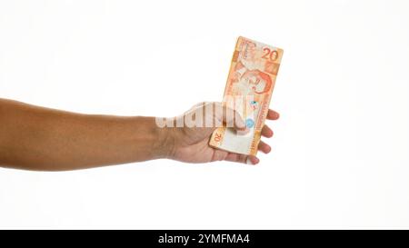 Hand holding philippine pesos over isolated white background ...