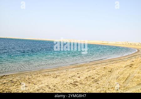 Sand dunes descending into the creek with limestone hills in the ...