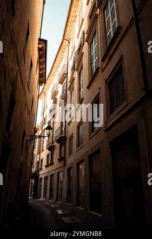A picturesque alleyway between two buildings in a town or city, leading ...