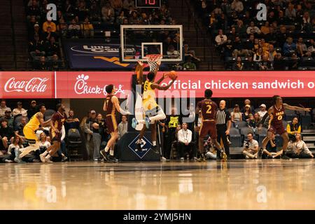 West Virginia guard Toby Okani (5) controls the ball against Houston ...