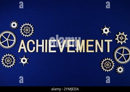 Achievement alphabet letters with gears element on navy blue background ...