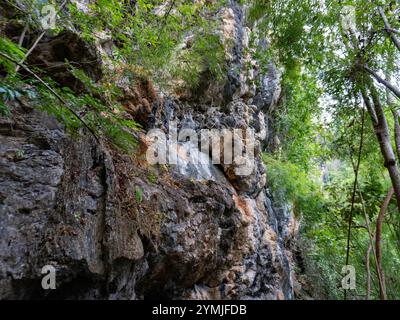 Amazing hillside cliff with compressed layer rock structure of volcanic ...