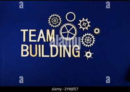 Team Building alphabet letters with gears element on navy blue ...