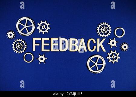 Feedback alphabet letters with gears element on navy blue background ...