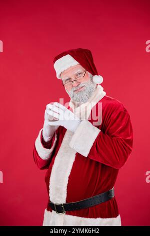 Jolly Santa smiling at camera against doorway standing on floorboards ...