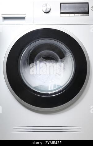 Washing machine with clothes and suds as background, closeup Stock ...