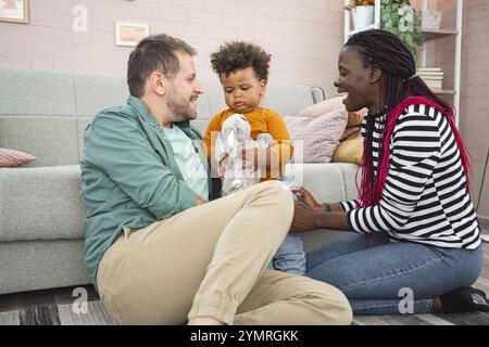 Multiracial family enjoying playtime together at home in the afternoon ...