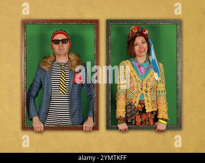 A couple of freaks hold picture frames and look at each other on a ...