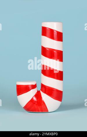 Blue and white striped ceramic vase surrounded by dark geometric ...