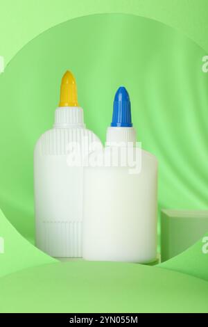 Bottles of glue on light green background, top view Stock Photo - Alamy
