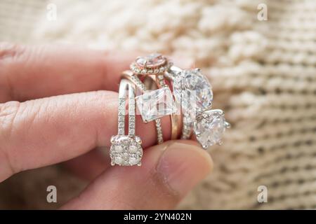 Closeup of female jeweler holding ring size gauge to check female ...