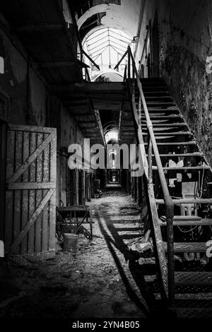 decrepit cell block and stairs leading to upper level at Eastern State ...